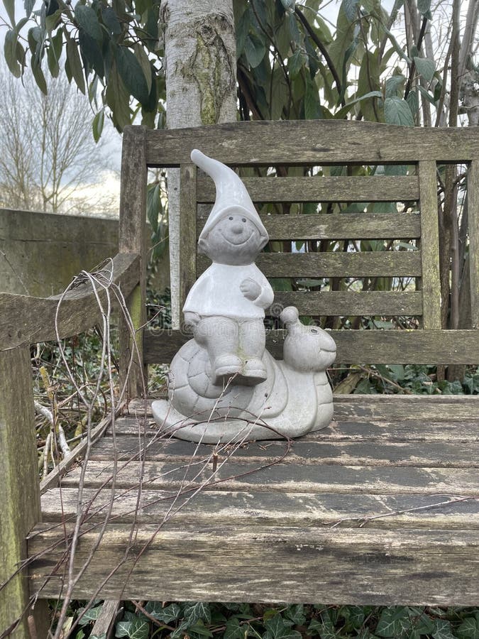 Garden Gnome Sitting on a Bench Stock Image - Image of blue, object ...
