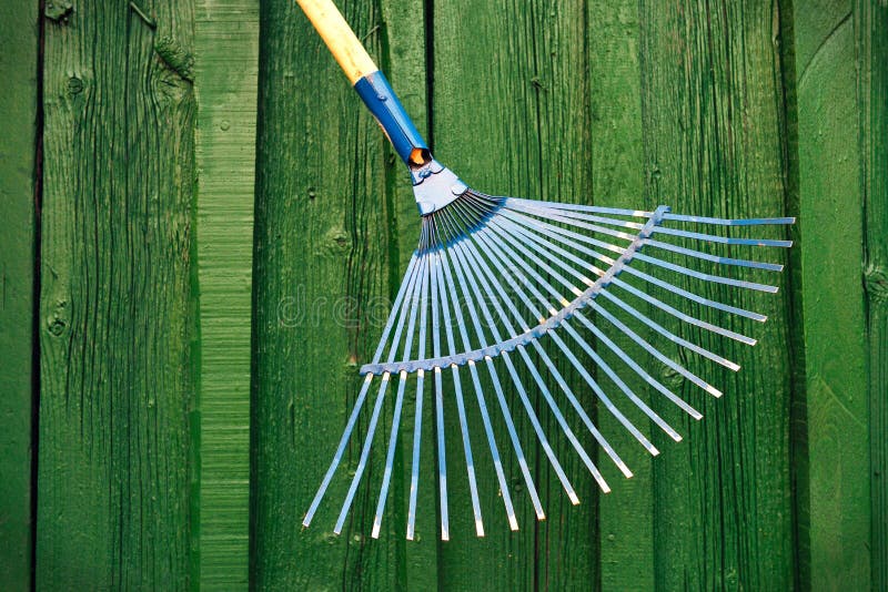 Garden Rake Against Green Wooden Background Stock Photo - Image of ...