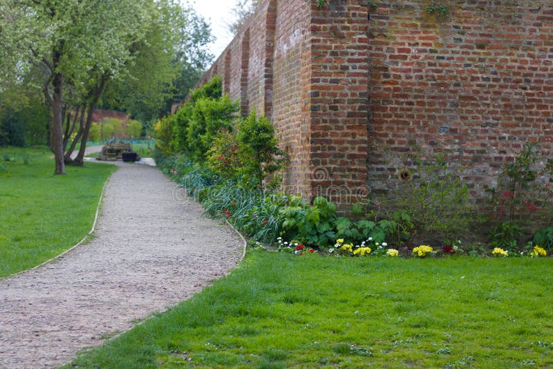 Garden Scene Showing Path with Corner of Brick Wall and Ground Cover ...