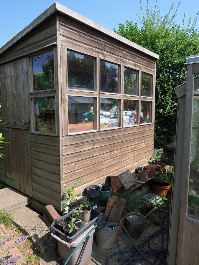 A Large Wooden Garden Shed with Windows in One Side Stock Photo - Image ...
