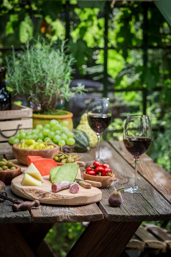 Garden Table with Snacks and Wine in the Garden Stock Photo - Image of ...