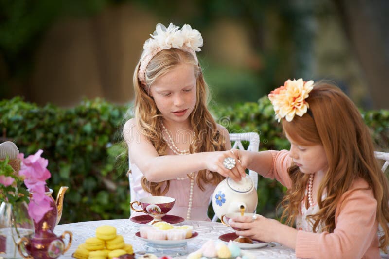 Garden Tea Time. Two Young Girls Having a Tea Party in the Backyard ...