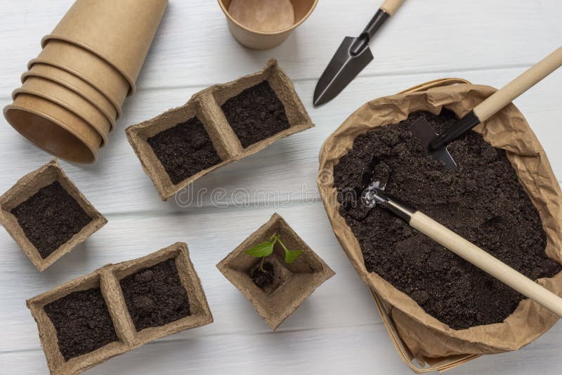 Garden Tool in a Paper Bag with Soil. Peat and Paper Pots with Soil ...