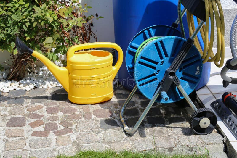 Watering Tools in the Garden Stock Photo - Image of tool, summer: 124088696