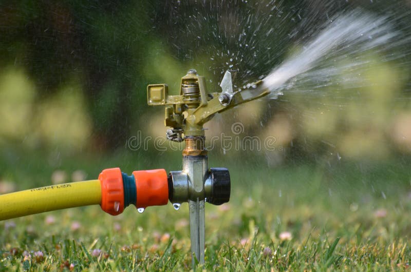 Garden Water Sprinkler in Action Stock Image - Image of sprinkling ...