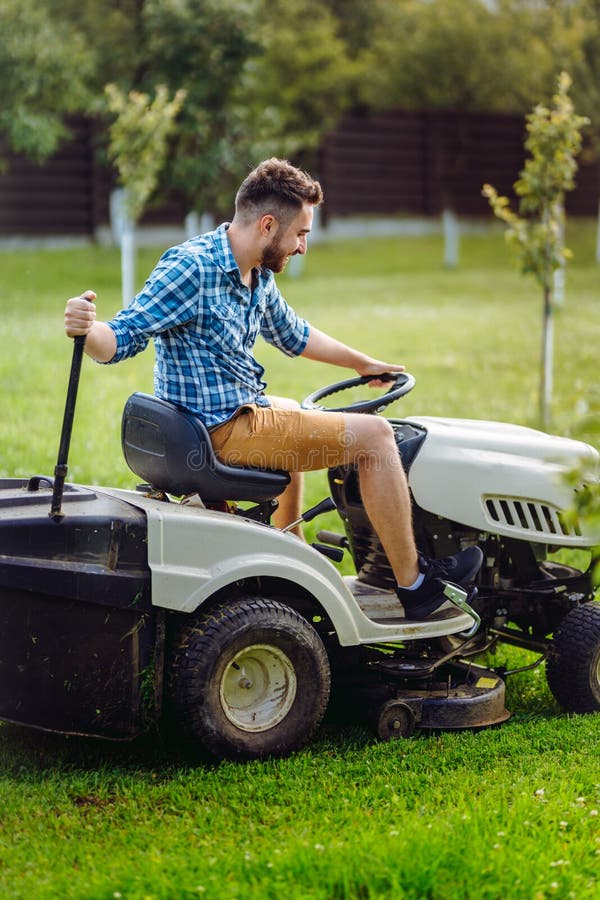 Gardener Using Lawn Tractor for Mowing Grass in Garden. Stock Image ...