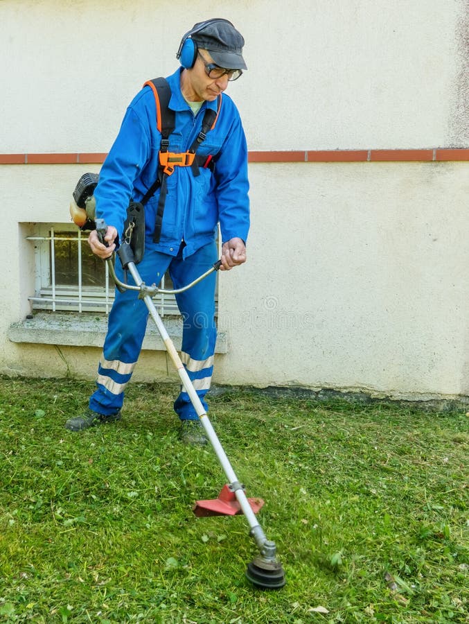 Gardener Worker with Trimmer in Green Yard Stock Photo - Image of ...