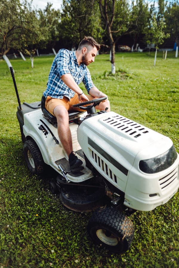 Gardener Worker Using Lawn Tractor and Cutting Grass Stock Image ...