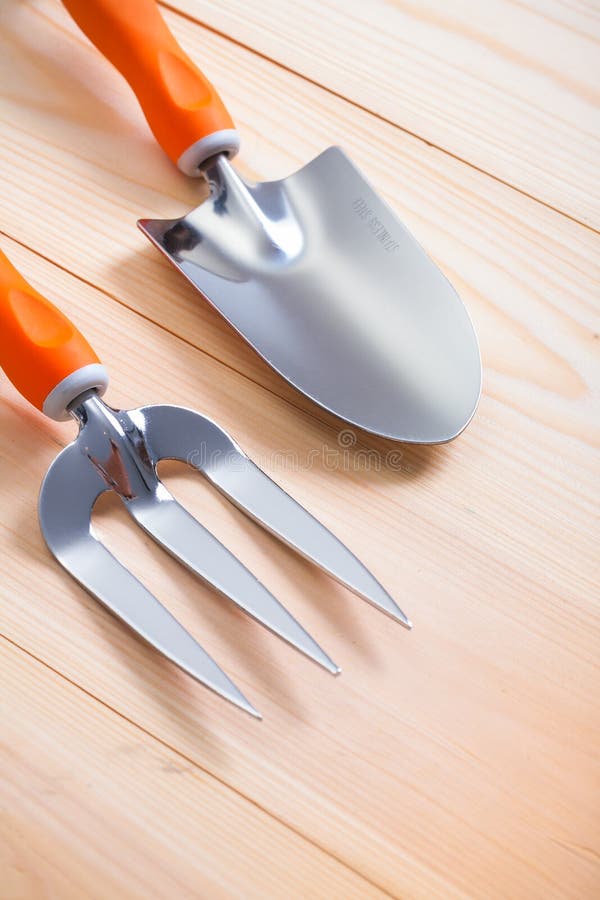Gardening Hand Tools - Trowel and Fork on Wooden Boards Stock Photo ...