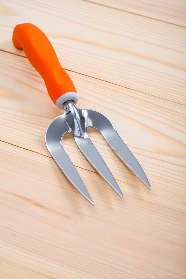 Gardening Tool Small Hand Fork on Wooden Boards Stock Photo - Image of ...