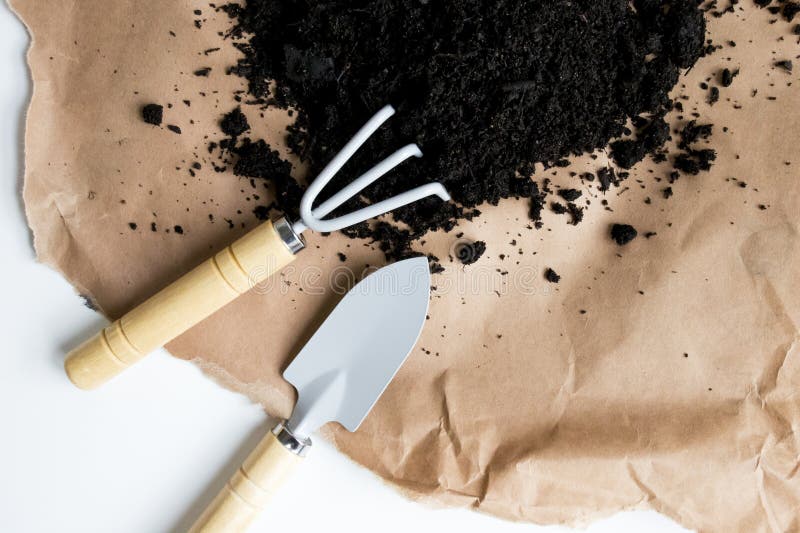 Gardening Tools with Soil on Brown Paper Background Stock Image - Image ...