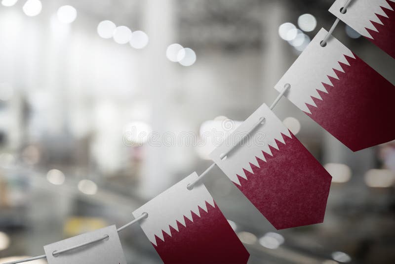 A Garland of Qatar National Flags on an Abstract Blurred Background ...