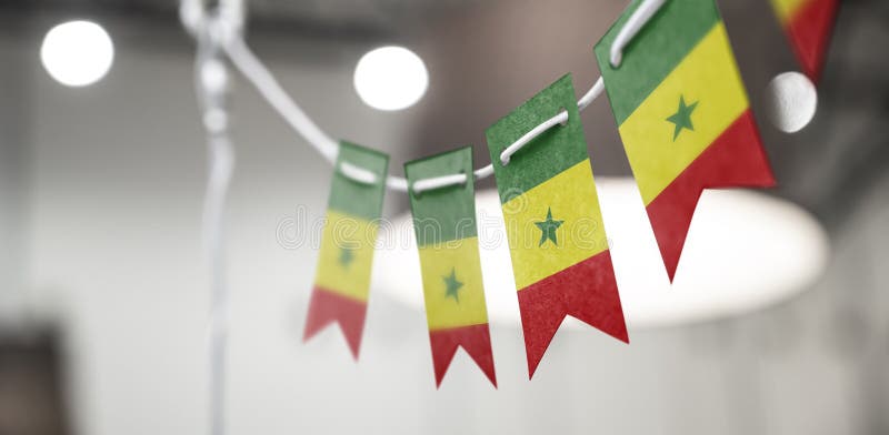 A Garland of Senegal National Flags on an Abstract Blurred Background ...