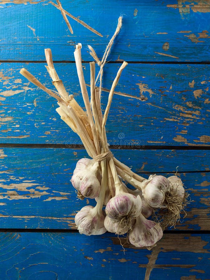 Garlic on Blue Wooden Table Stock Photo - Image of closeup, organic ...