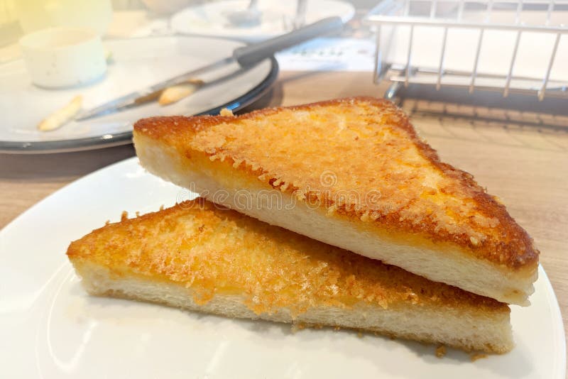 Garlic Bread Cut into Triangles on a White Plate Stock Photo - Image of ...