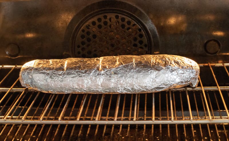 Bread in foil in the oven stock image. Image of wrapped - 300178025