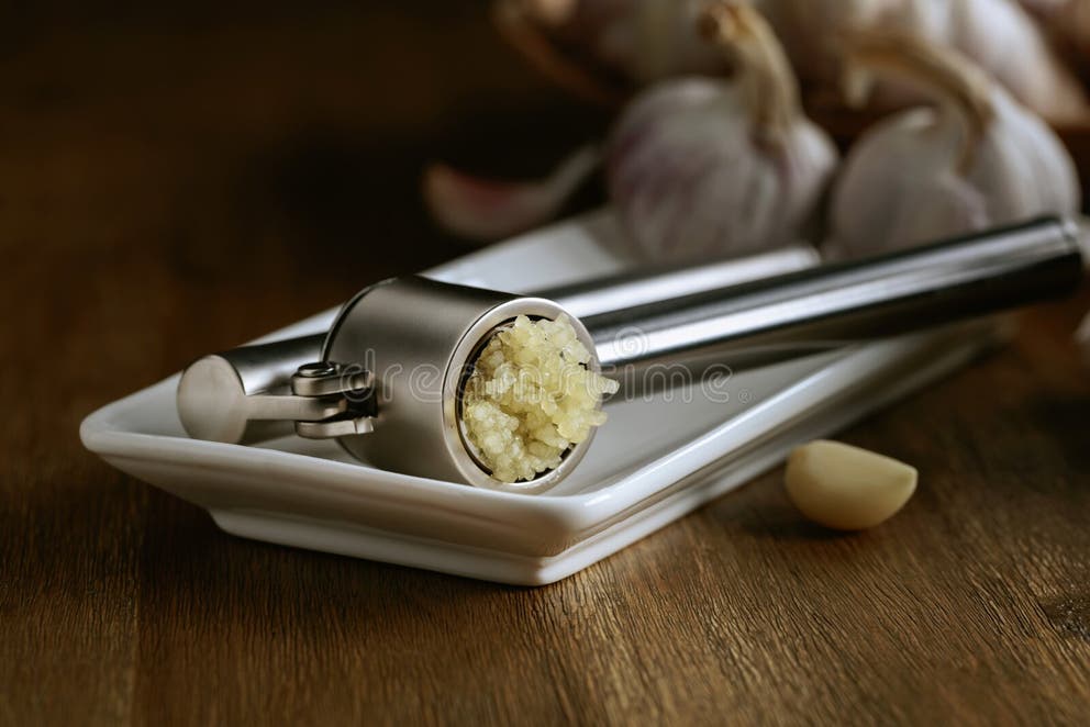 Garlic Bulbs and Garlic Press on a Wooden Table Stock Image - Image of ...