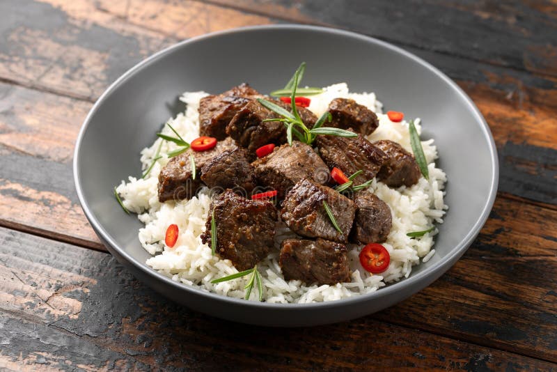 Garlic Butter Beef Steak Bites with Rice Stock Photo - Image of butter ...