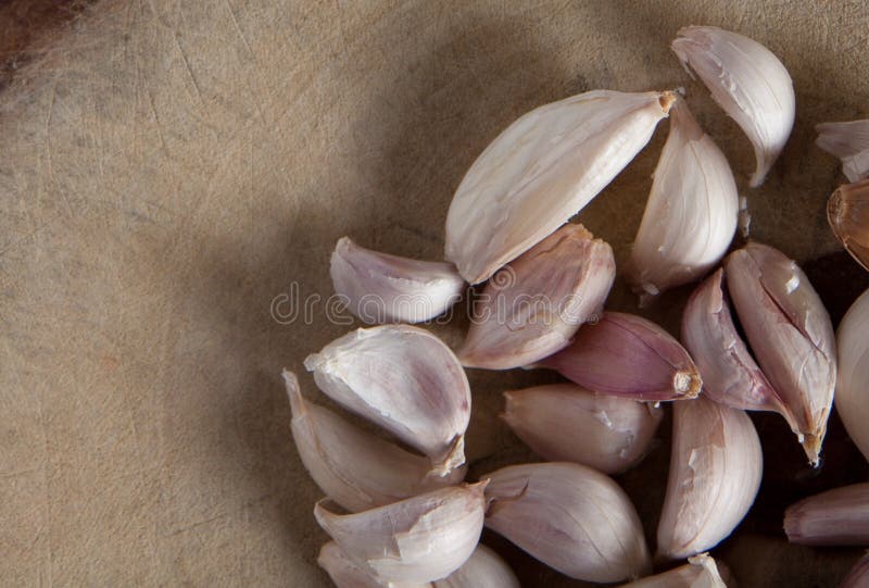 Garlic on a chopping block stock photo. Image of garlic - 49421652