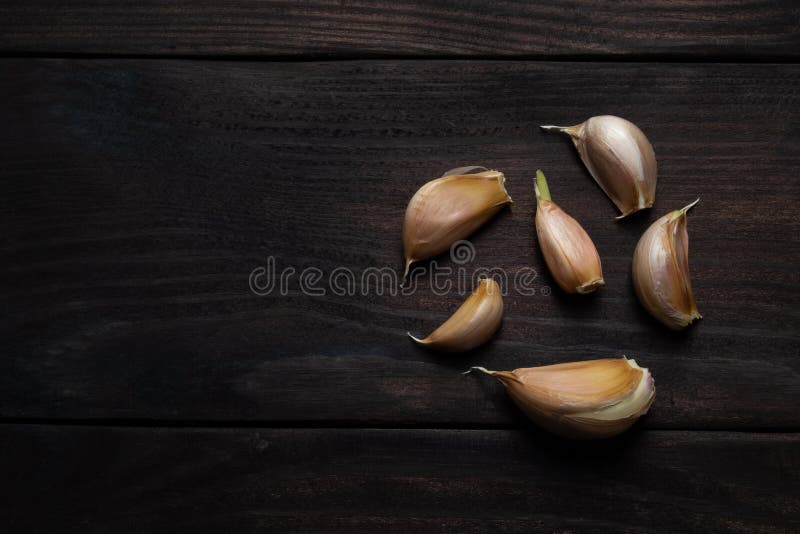Garlic Cloves on Wood Texture. Space for Text. Top View Stock Photo ...