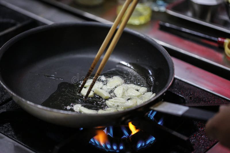Garlic is Frying on Pan with Oil, Garlic with Frying Pan Stock Image ...