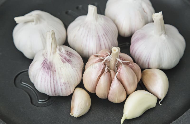 Garlic and a Frying Pan on Table Close-up. Stock Image - Image of fresh ...