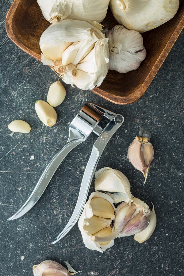 Garlic and garlic press. stock image. Image of fresh - 87540855