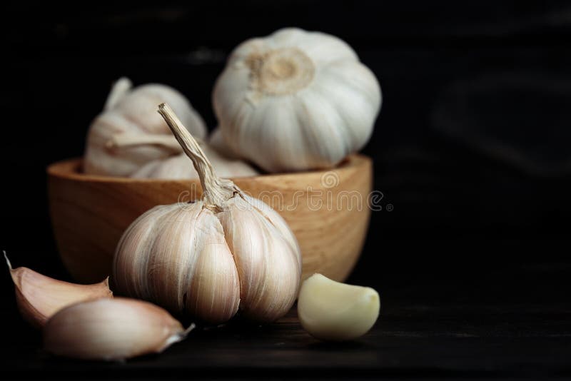 Garlic Ingredient Herb on Wood Front View Dark Background Stock Photo ...