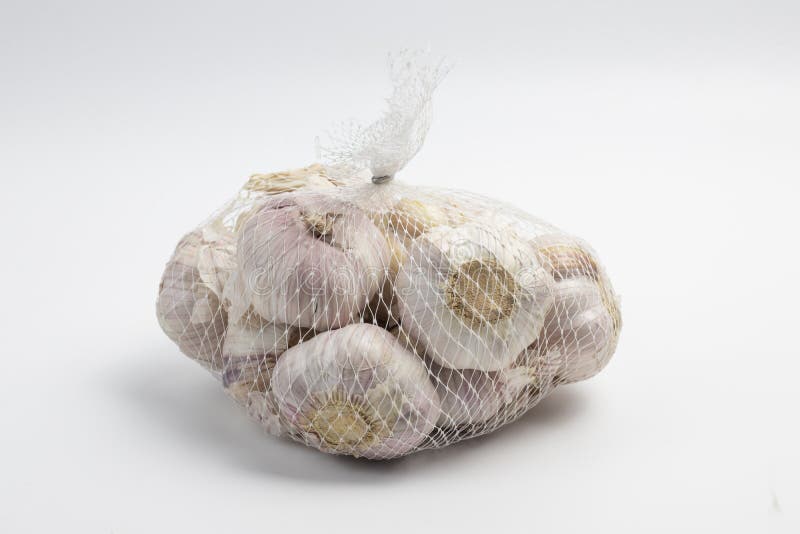 Garlic in a Net Bag on a White Background Stock Image - Image of ...
