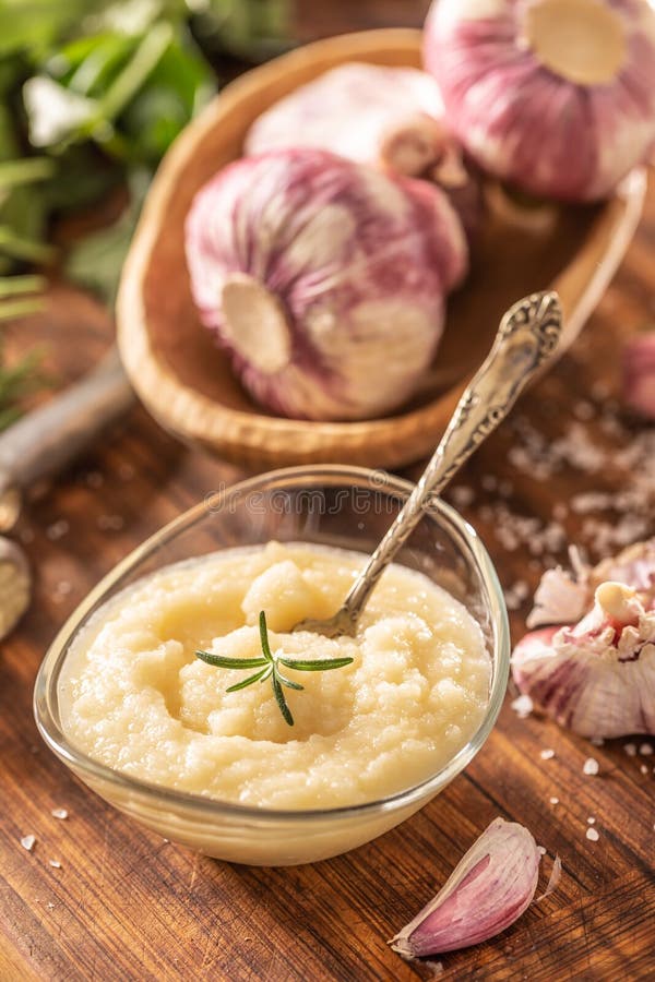 Garlic Paste in a Glass Bowl with Peeled Garlic, Salt, Crusher and ...
