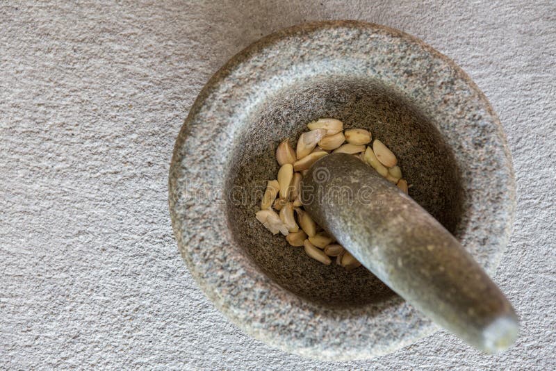 Garlic in stone mortar stock image. Image of aromatic - 130237883