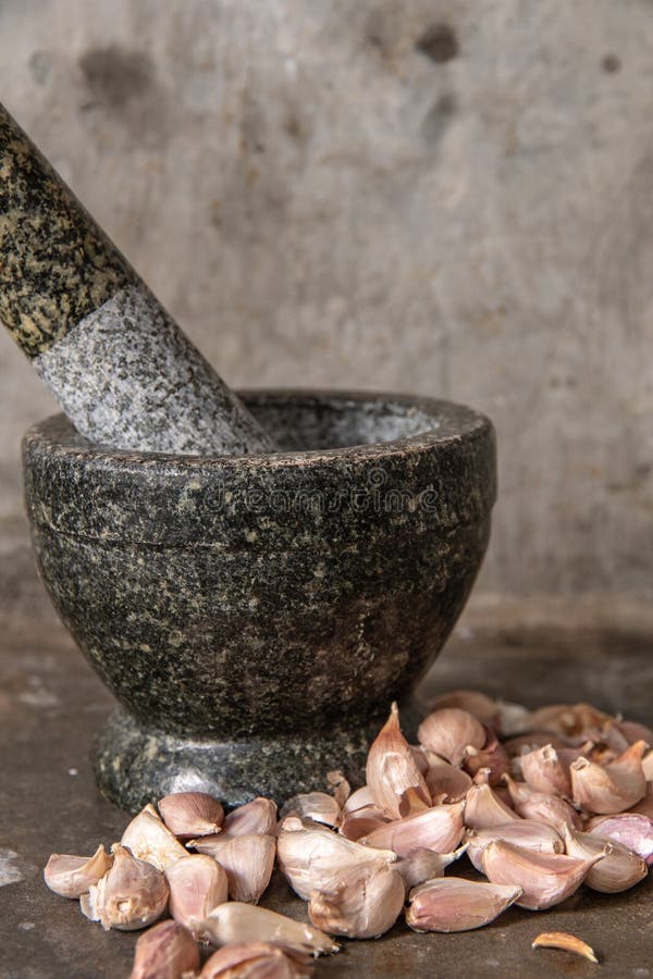 Garlic with Stone Mortar on Top of Cement Table Stock Image - Image of ...