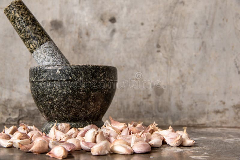 Garlic with Stone Mortar on Top of Cement Table Stock Image - Image of ...