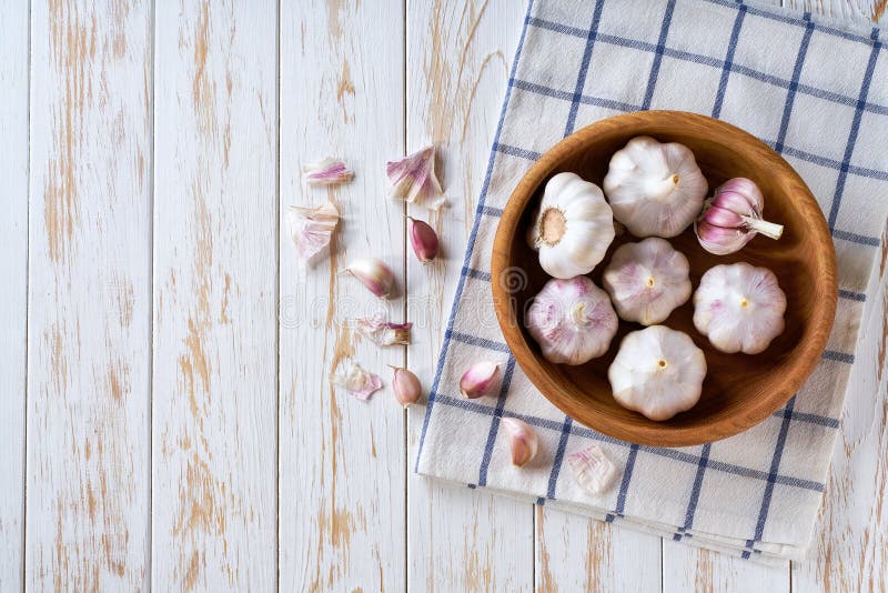 Garlic in a Wooden Bowl on a White Kitchen Table, Top View Stock Image ...