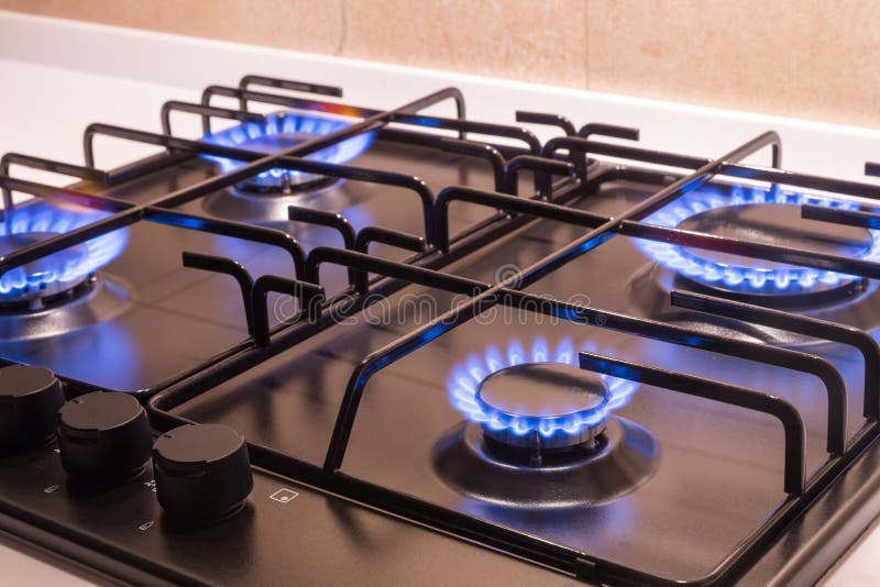 Gas Burner on Black Modern Kitchen Stove Stock Image - Image of glow ...