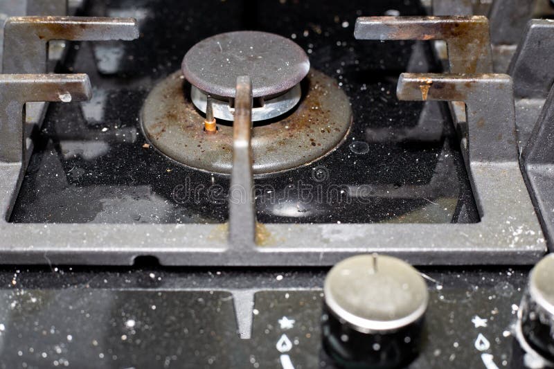 Gas Burner on Black Tempered Glass Surface with a Layer of Dust and ...