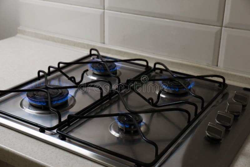 Gas Cooktop with Burning Blue Flames in Kitchen Stock Photo - Image of ...
