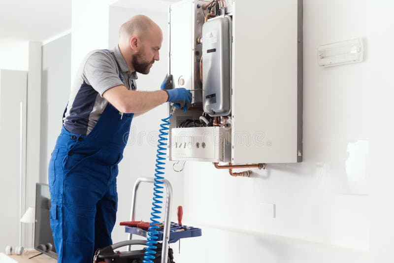 Professional Engineer Servicing a Boiler at Home Stock Photo - Image of ...