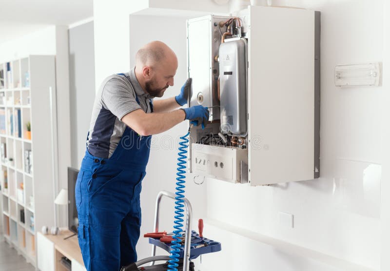 Professional Engineer Servicing a Boiler at Home Stock Image - Image of ...