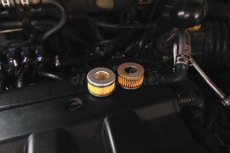Gas Filter Comparison New and Old Placed on Car Engine Compartment ...