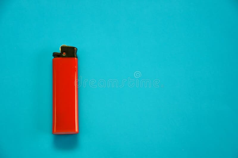 Gas Lighter of Red Color on a Blue Background. Close-up Surface for ...