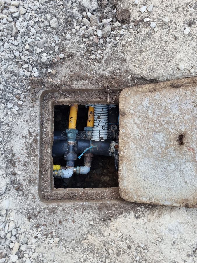 A Gas Meter is Sitting in a Hole in the Ground Stock Image - Image of ...