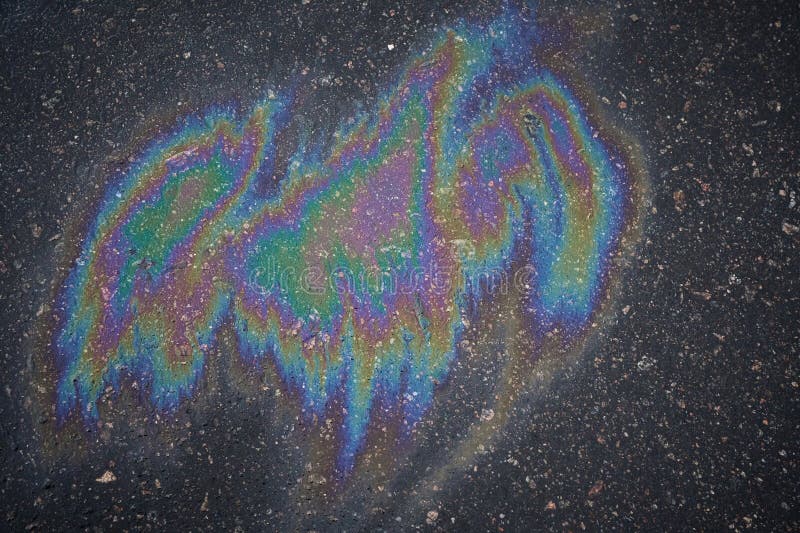 Gasoline or Oil Spill on Asphalt Creating Rainbow Sheen Reflecting ...