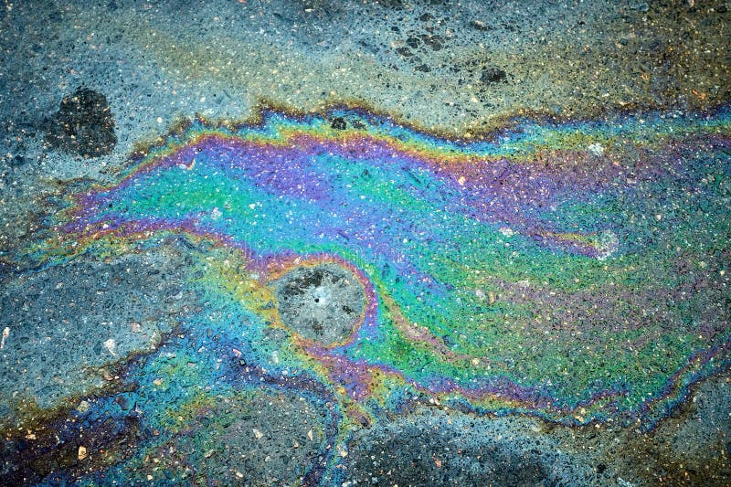 Gasoline or Oil Spill Creating Rainbow Pattern on Asphalt Surface Stock ...