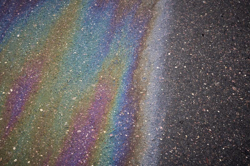 Gasoline or Oil Spill Creating Rainbow Sheen on Asphalt Road Surface ...