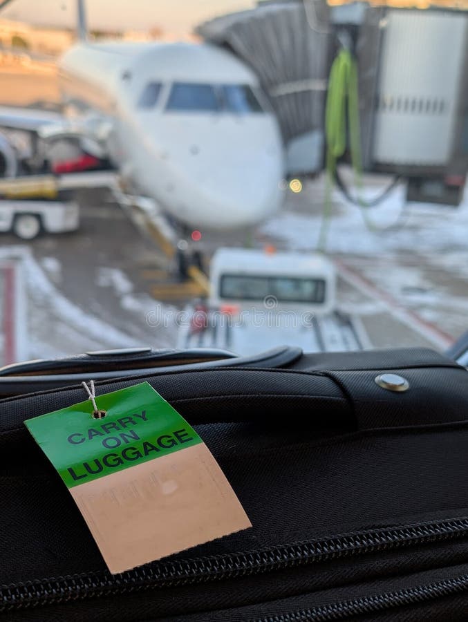 Gate Check Luggage Tag on a Roller Suitcase in an Airport. Stock Photo ...