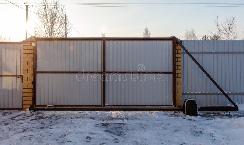 A Gate is Open and the Snow is Piled Up on the Ground Stock Photo ...