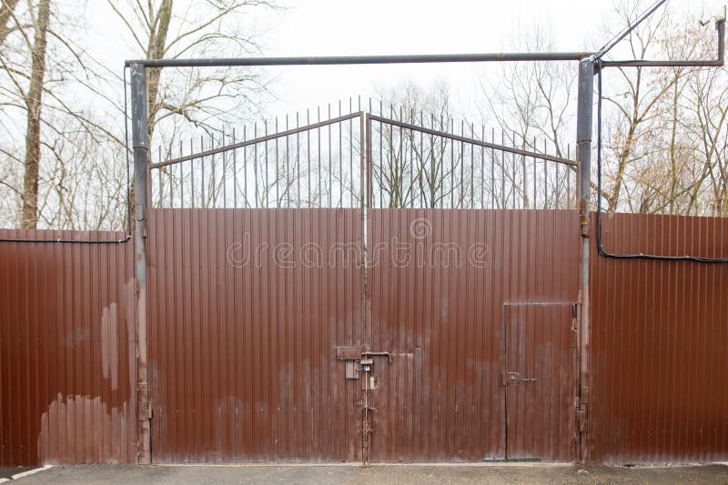 A Gate with a Rusty Lock is Open Stock Photo - Image of road, street ...