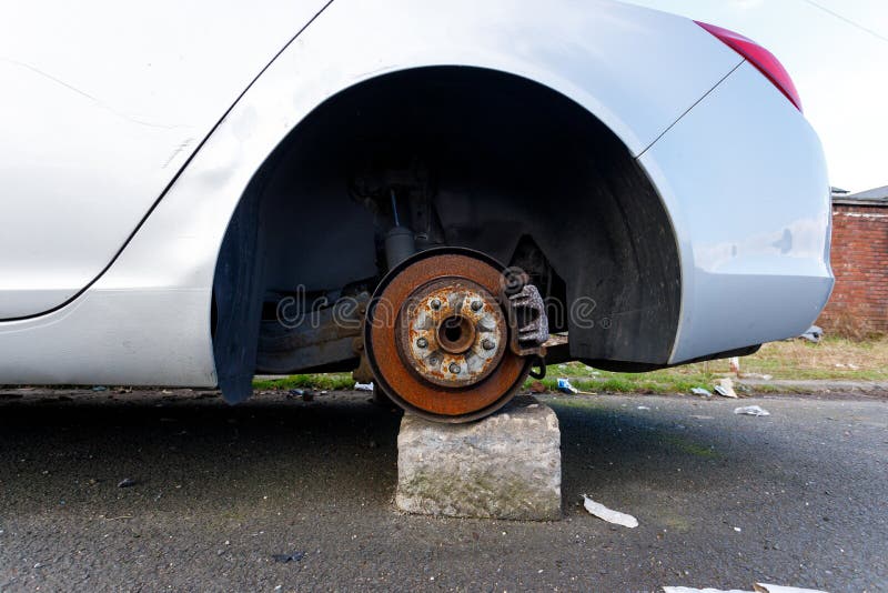 A Broken Down Car with Wheels Removed on Bricks Stock Photo - Image of ...