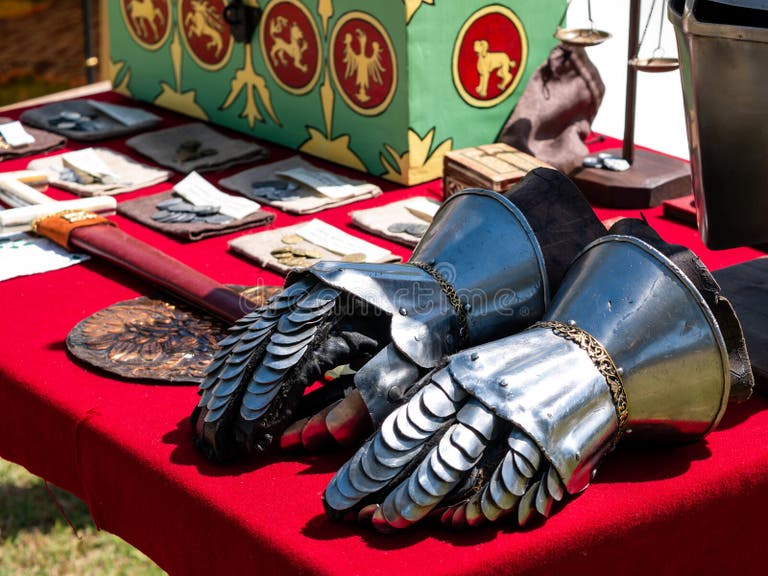 Gauntlets in Medieval Plates Laid on a Table with a Red Tablecloth ...